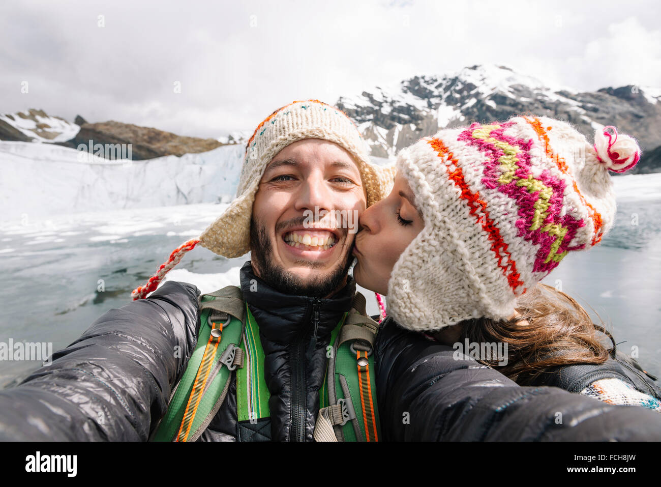 Peru couple wearing wool chullos and kissing Stock Photo - Alamy