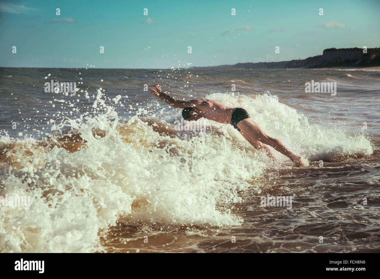 Brazil Bahia man jumping into the waves Stock Photo - Alamy