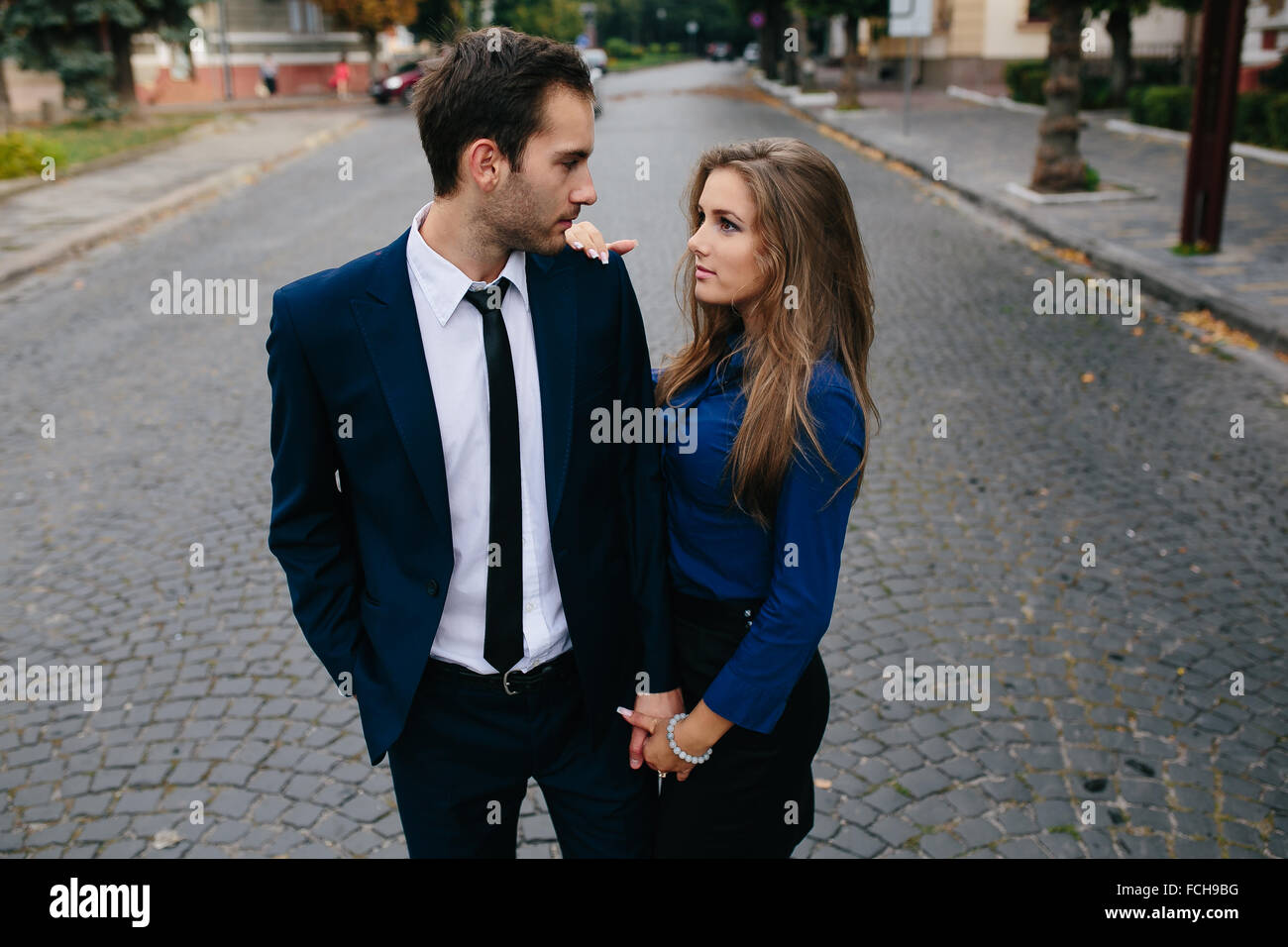 man and woman walking together on the street Stock Photo - Alamy