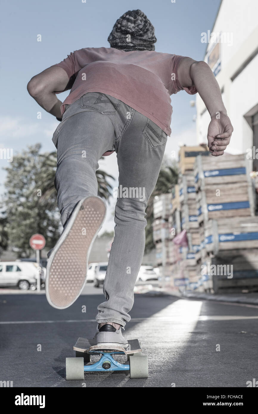 Rear view of a skateboarder on the street Stock Photo - Alamy