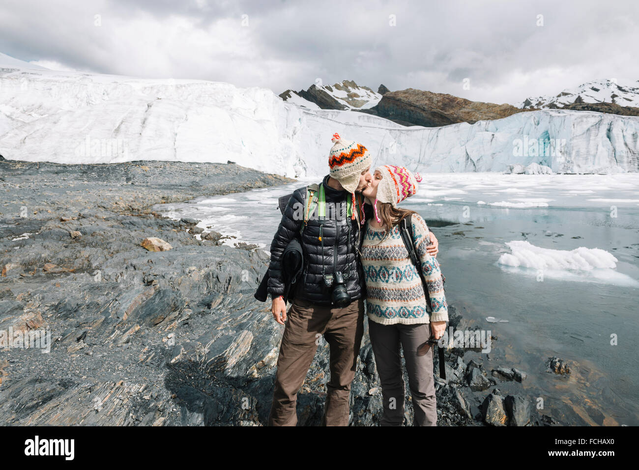 Peru couple wearing wool chullos and kissing in front of Pastoruri ...