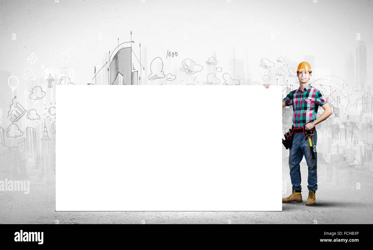 Handyman is holding an empty banner for your text hi-res stock ...
