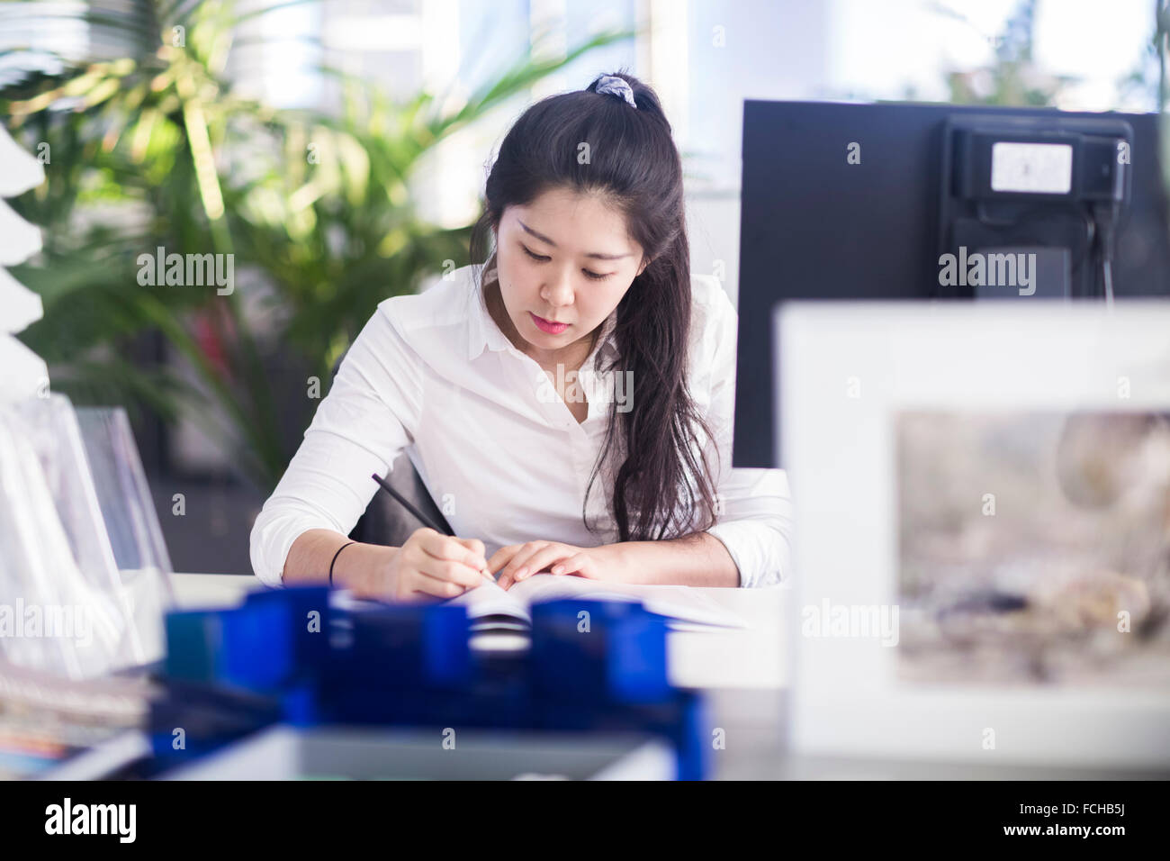 Chinese office worker working in corporate business Stock Photo - Alamy