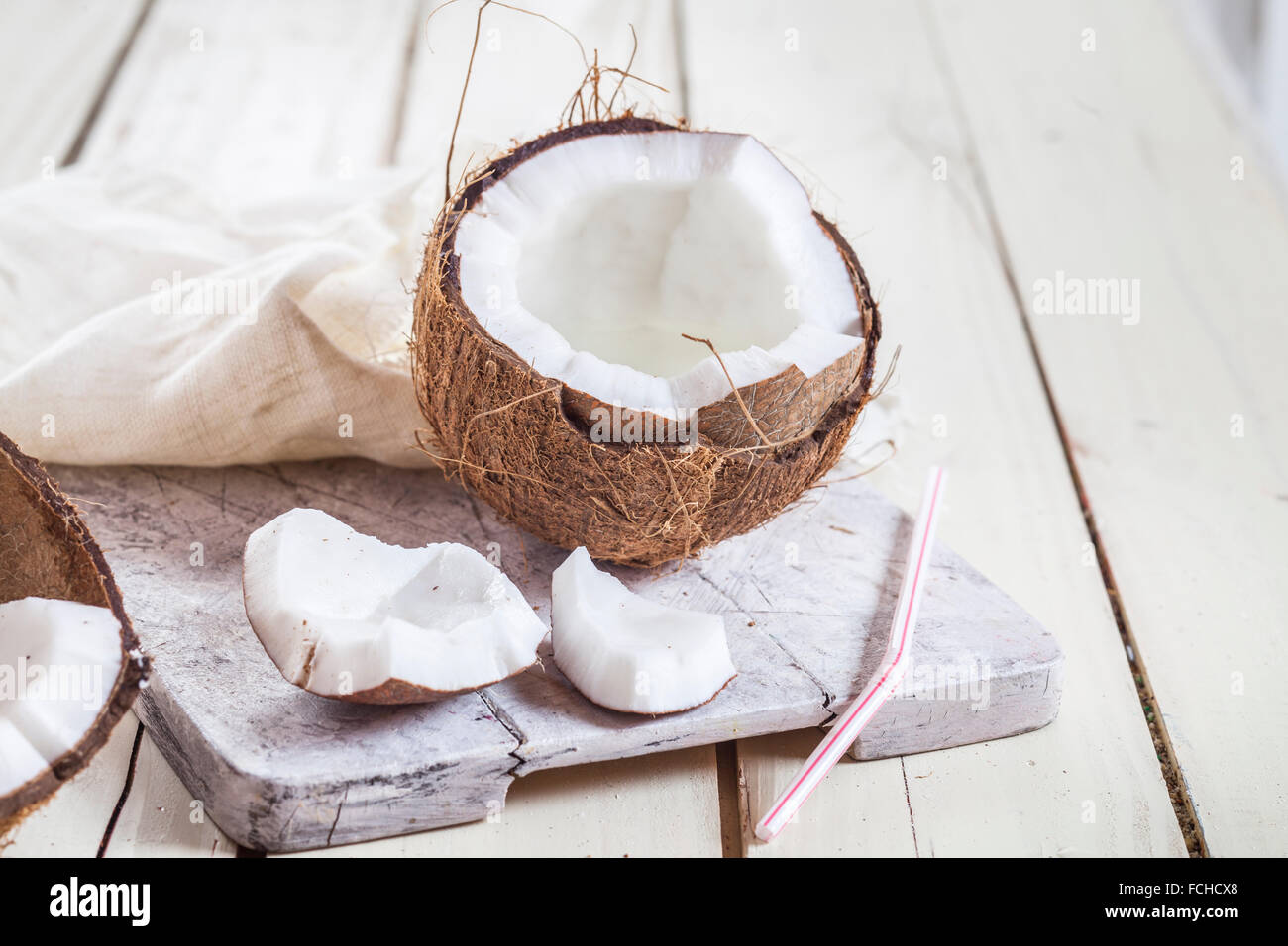 Opened coconut on wooden board Stock Photo - Alamy