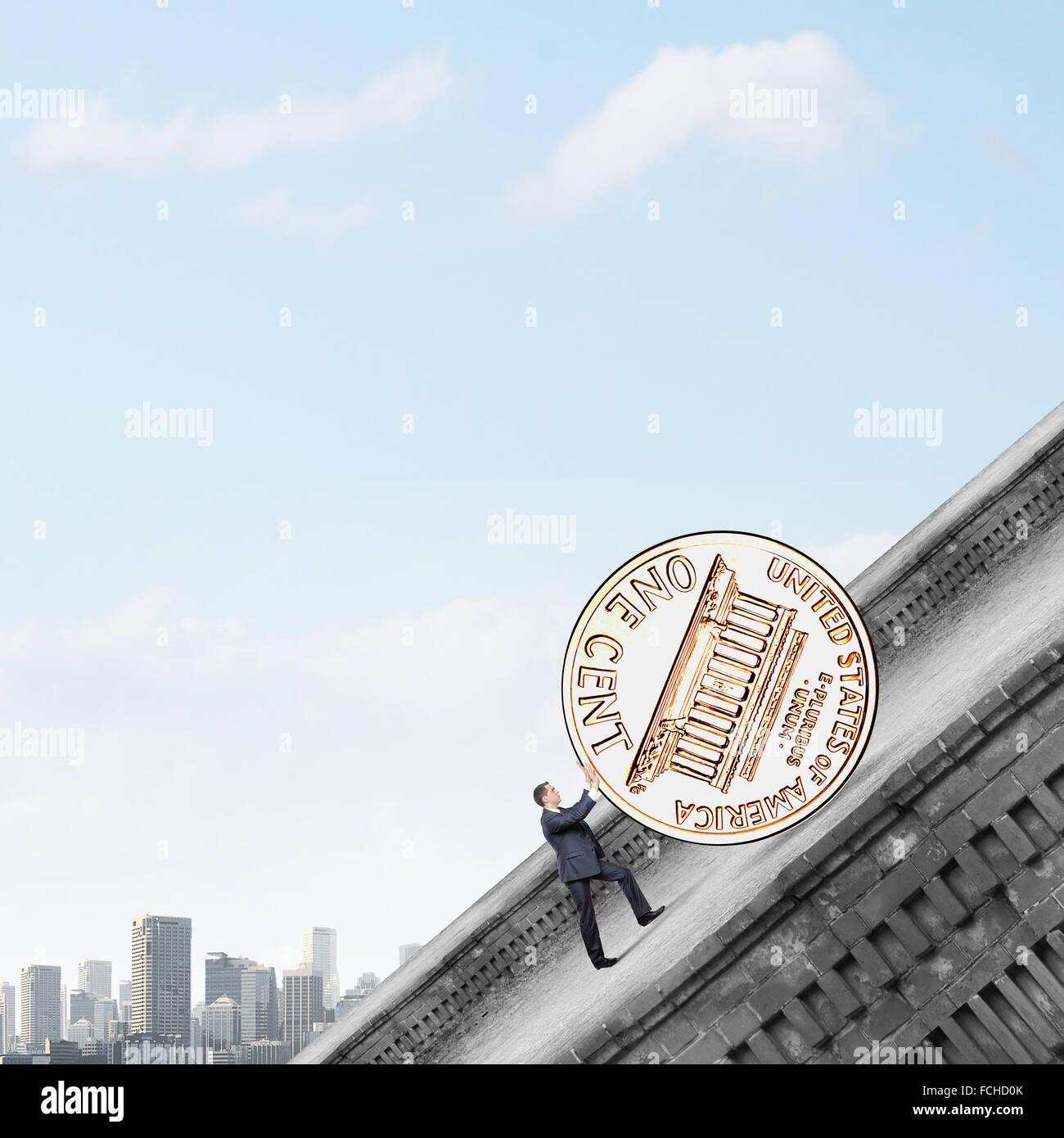 Businessman rolling cent coin up the hill Stock Photo - Alamy