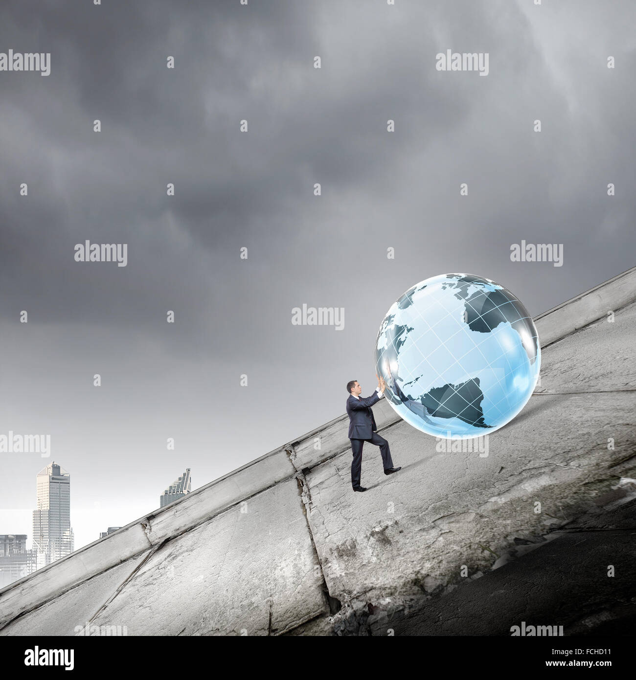 Businessman rolling Earth planet up the hill Stock Photo - Alamy