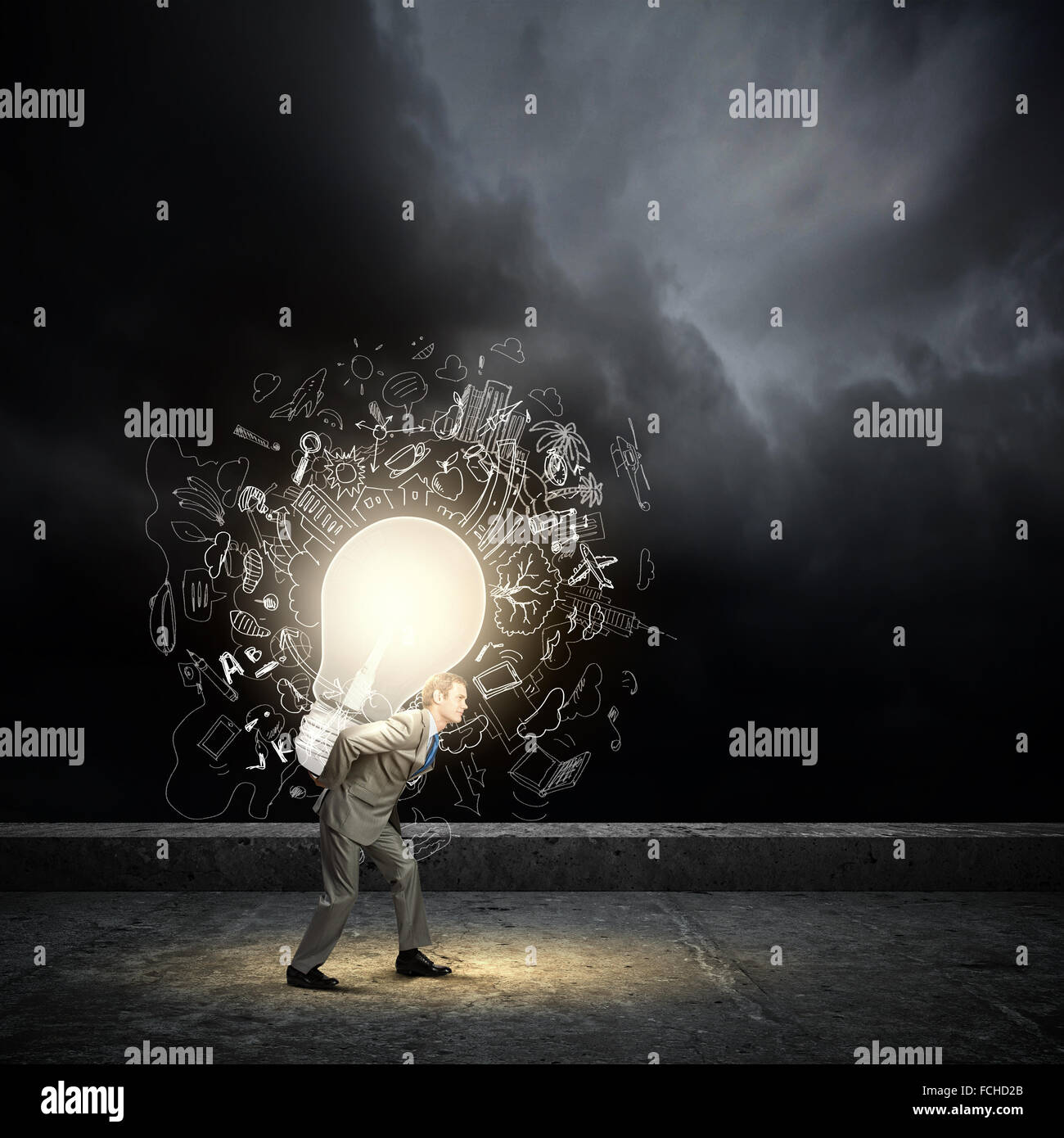 Tired businessman carrying light bulb on his back Stock Photo - Alamy
