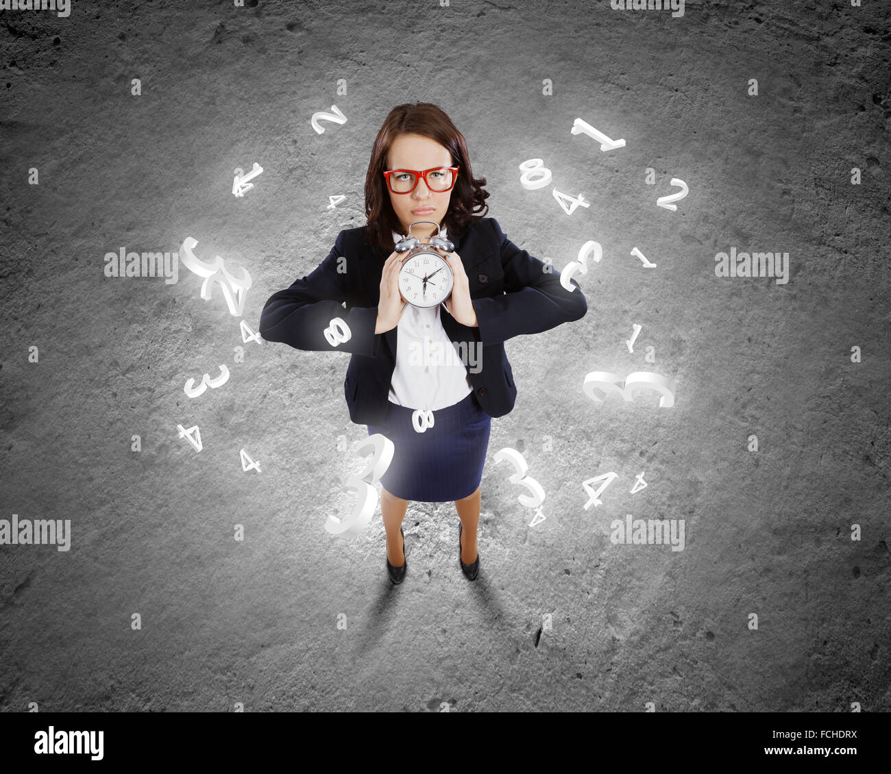 Top view of upset businesswoman holding alarm clock Stock Photo - Alamy