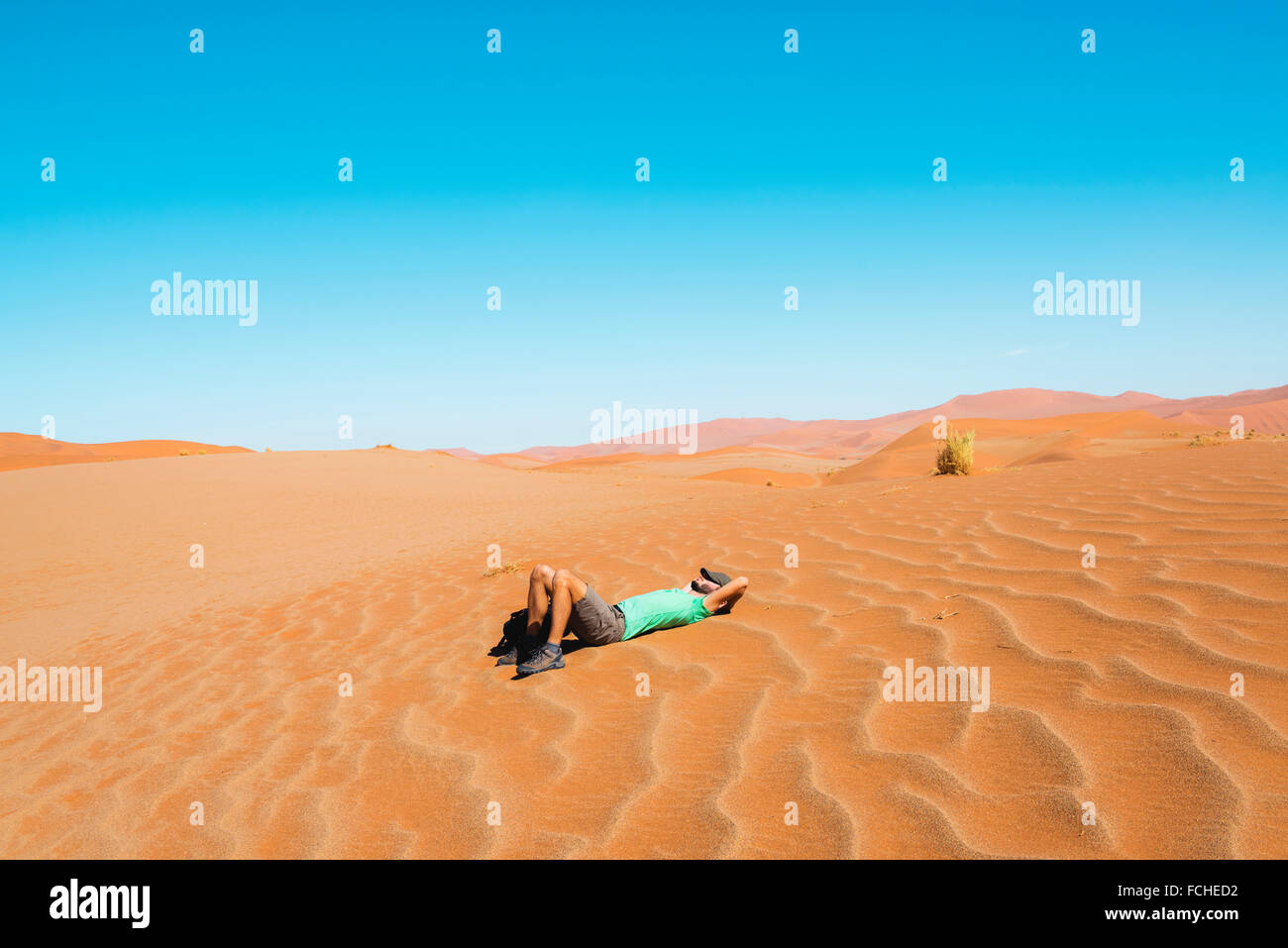 Namibia Namib Desert Sossusvlei Man resting on a dune Stock Photo - Alamy