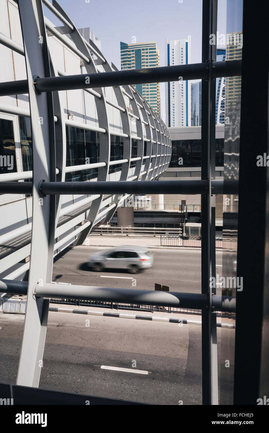 UAE Dubai urban scene skywalk driving car and skyscrapers in the ...