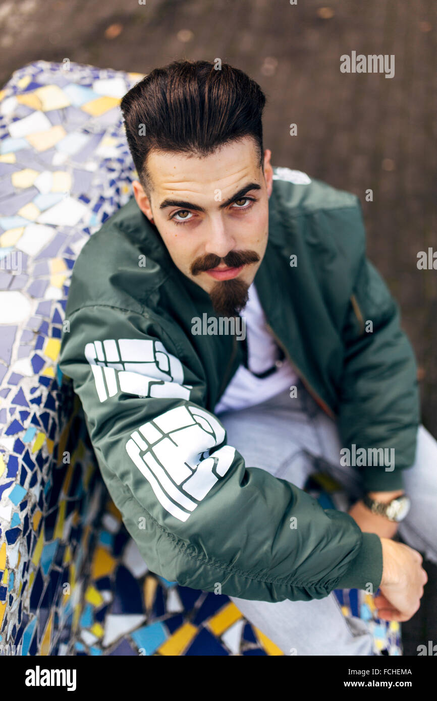 Portrait of a stylish young man looking up to camera Stock Photo - Alamy