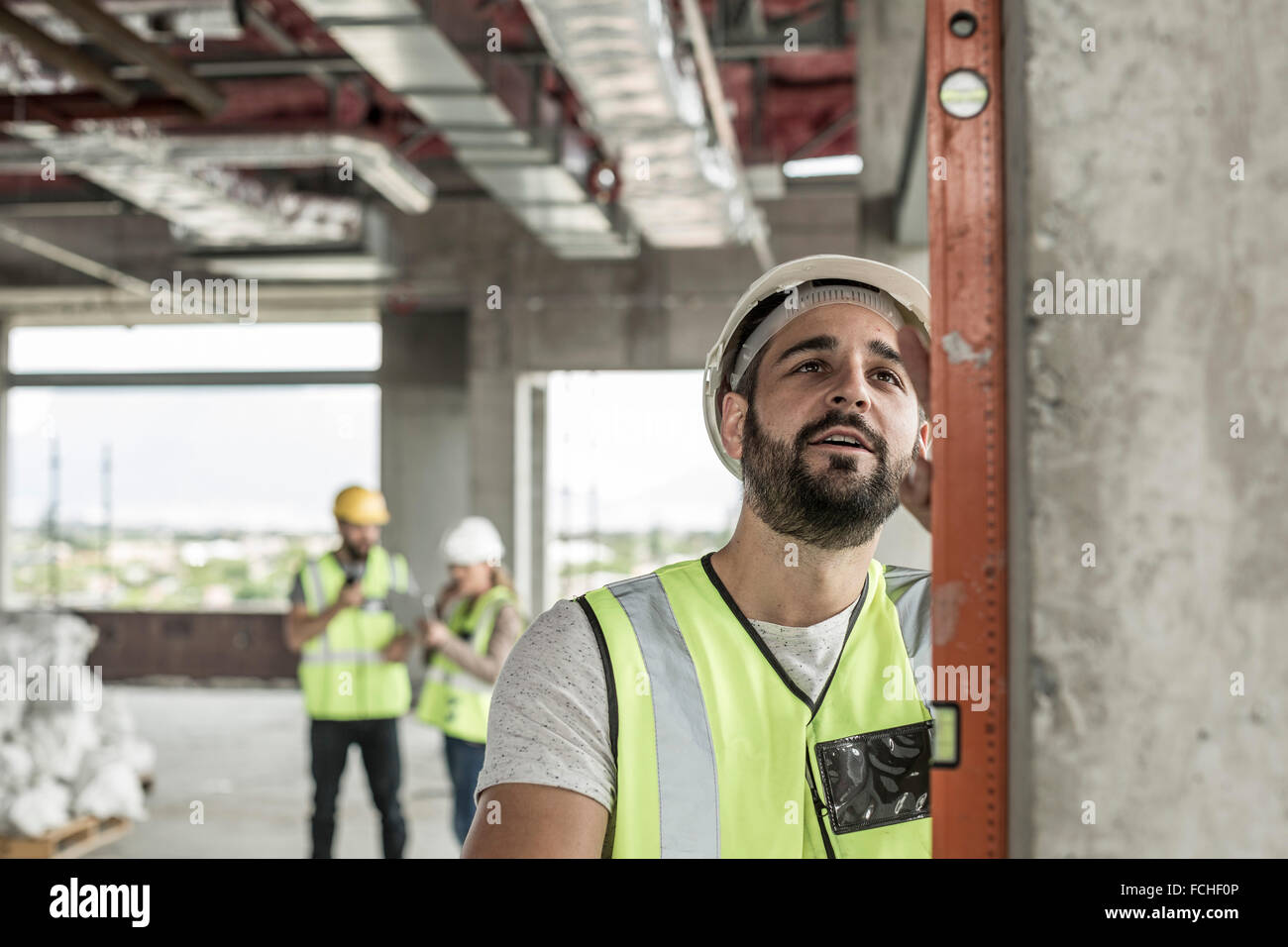 Construction worker using water level in construction site Stock Photo ...