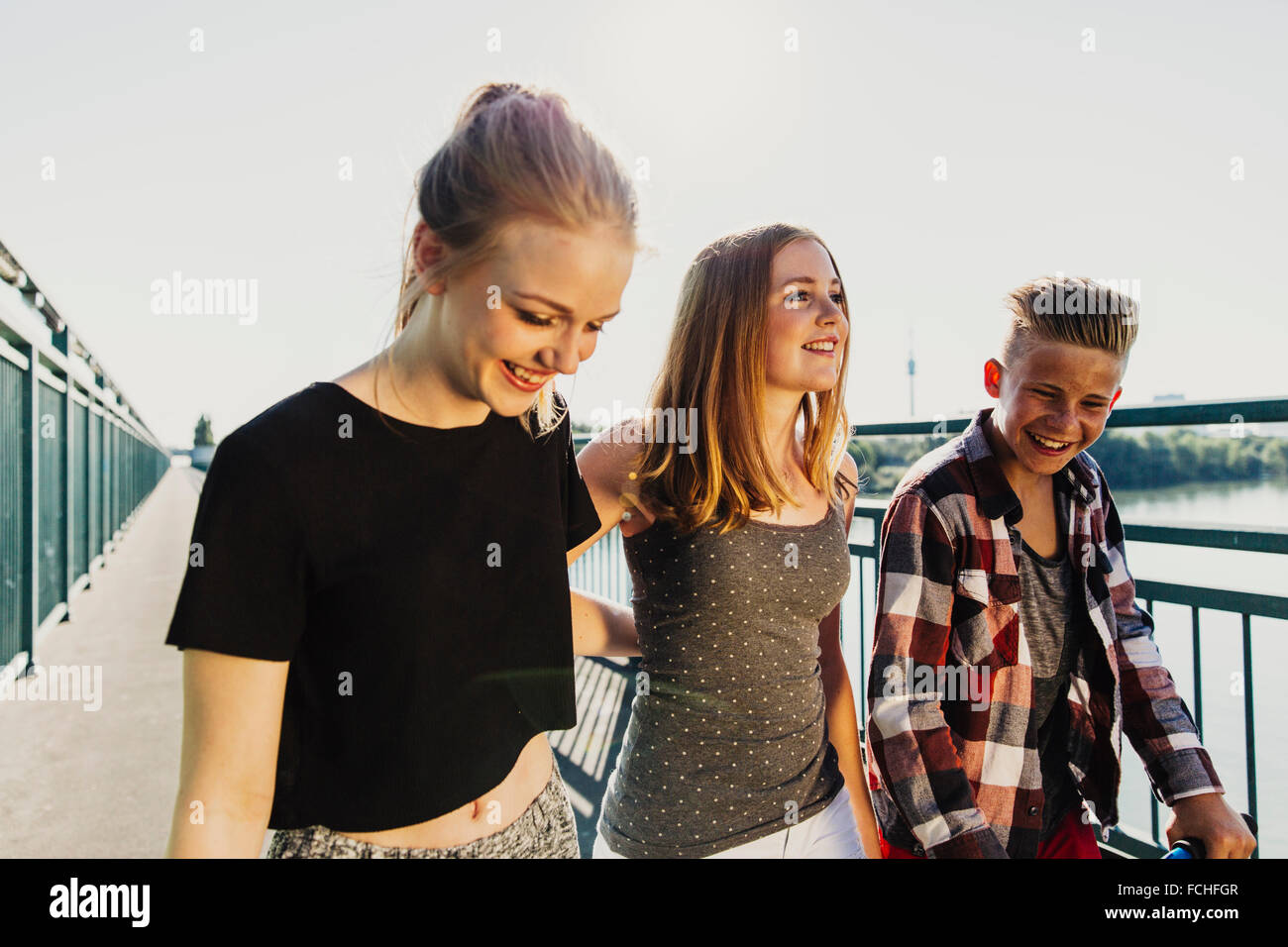 Three smiling teenagers on a bridge hi-res stock photography and images ...
