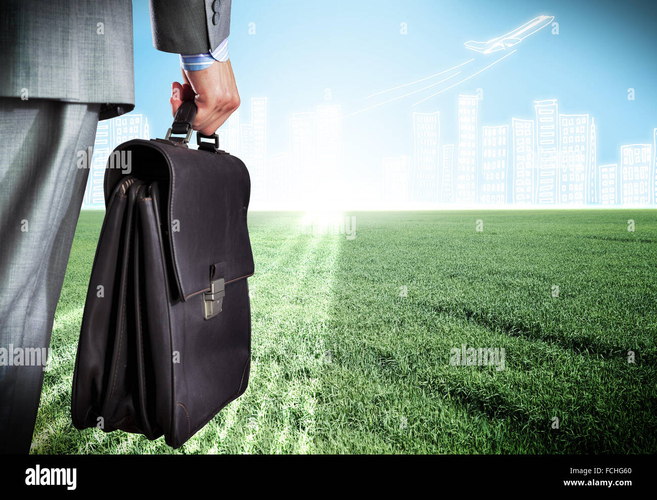 Rear view of businessman with briefcase and sketches at background ...