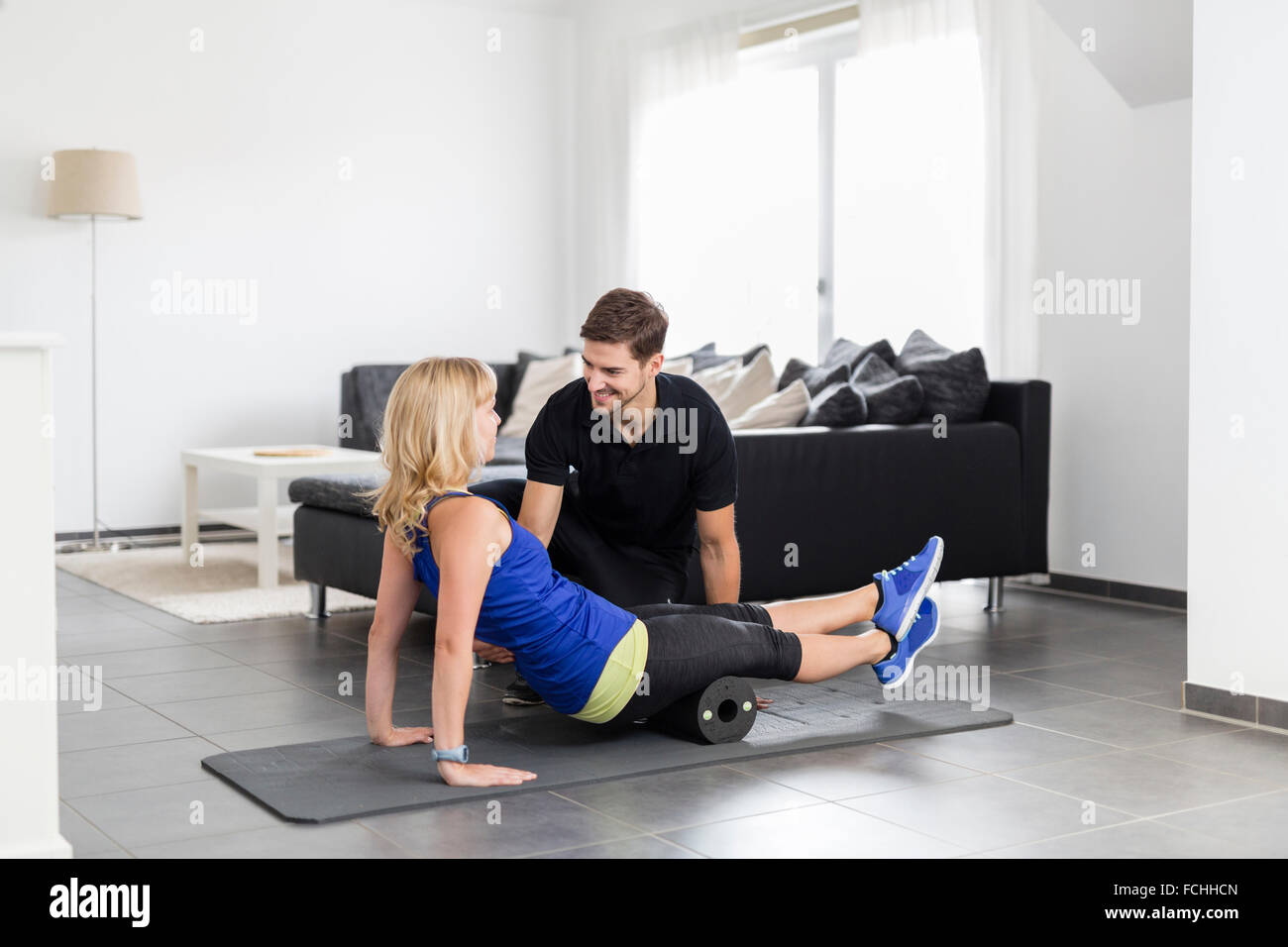 Coach doing exercises woman at home Stock Photo - Alamy