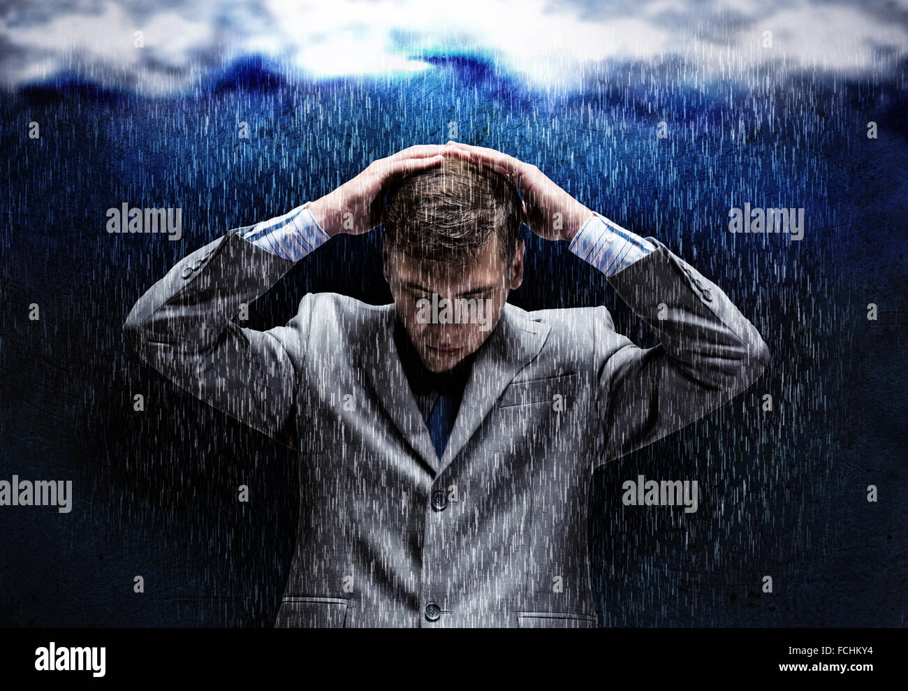 Young businessman under rain covering head with hands Stock Photo - Alamy
