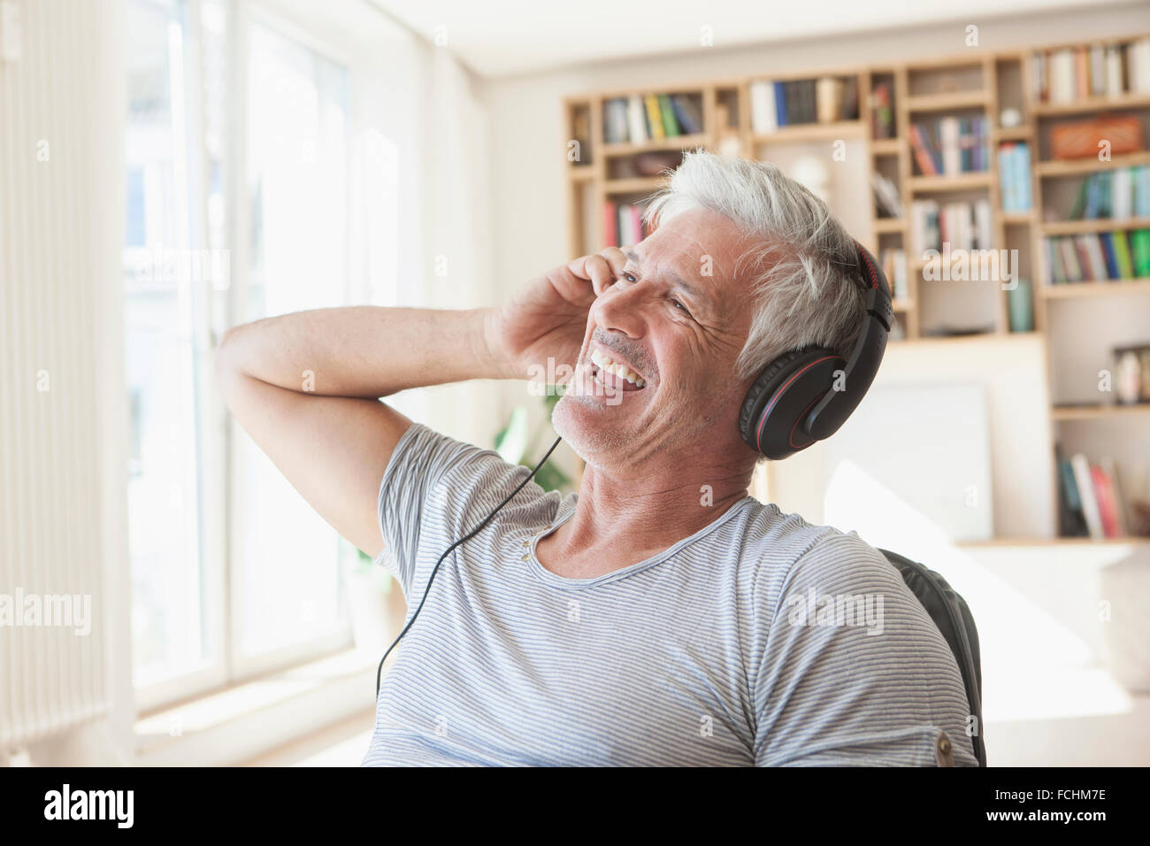 Portrait of relaxed man hearing music headphones at home Stock Photo ...