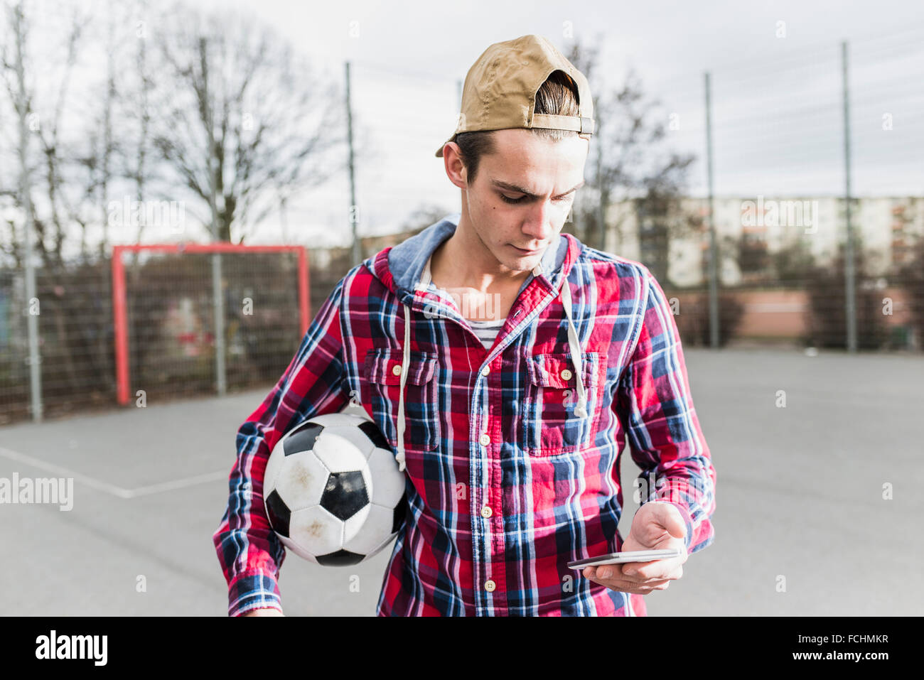 Young football player smartphone Stock Photo - Alamy