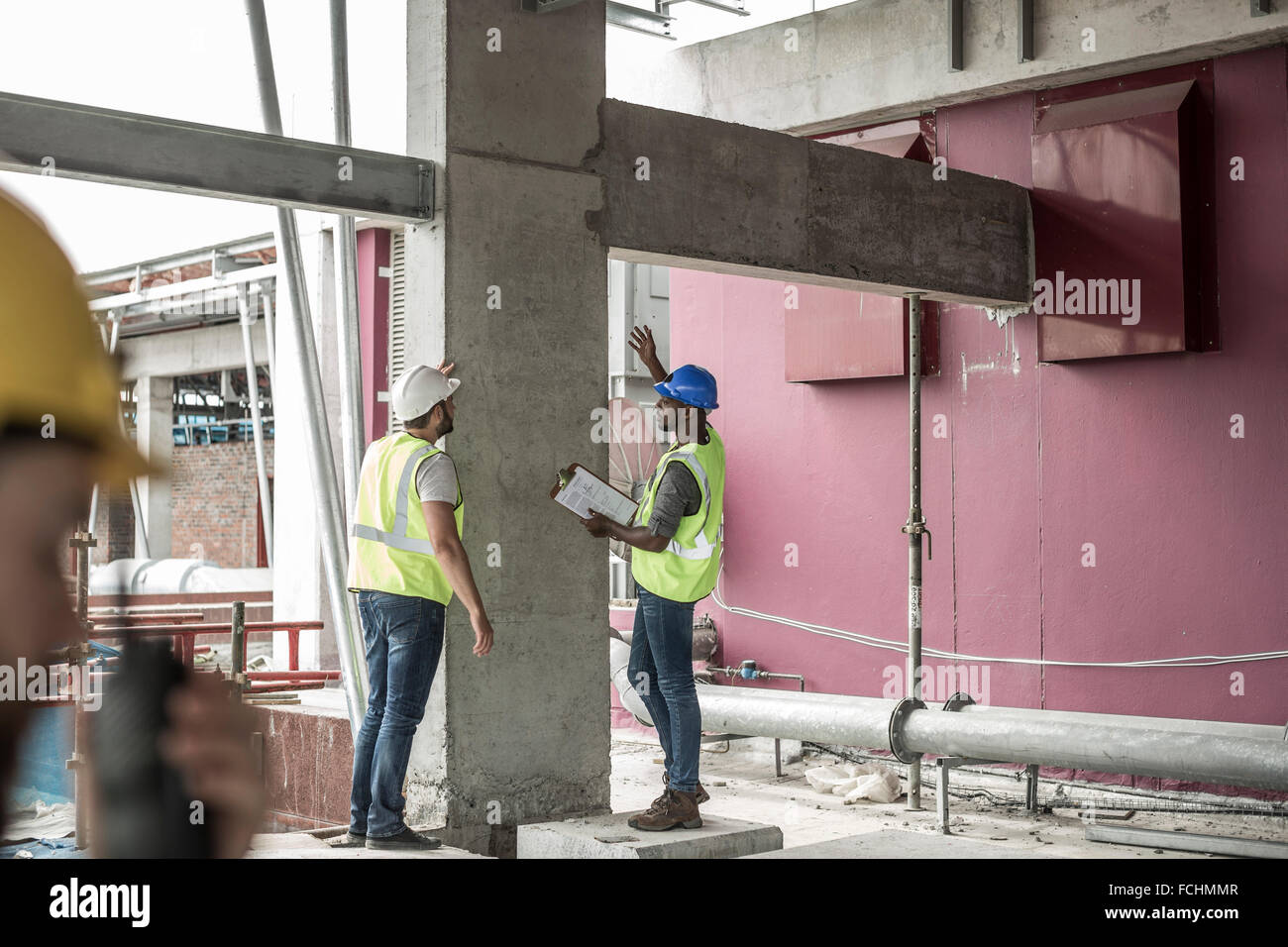 Construction workers discussing in construction site Stock Photo - Alamy