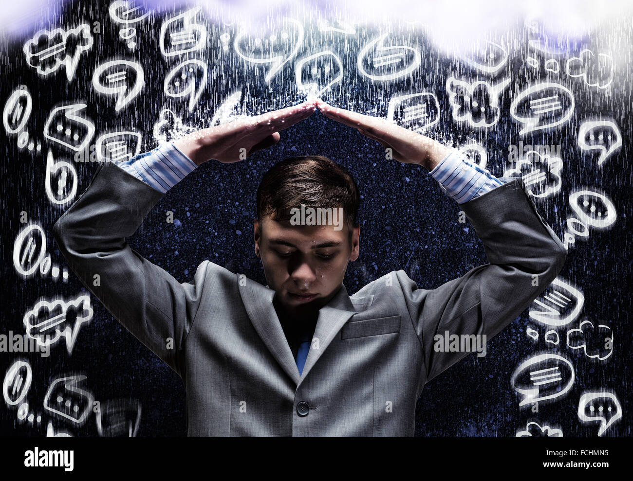 Young businessman under rain covering head with hands Stock Photo - Alamy