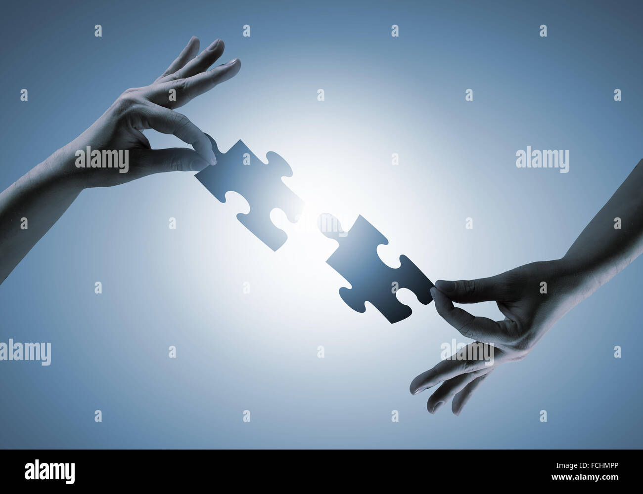 Close up image of hands connecting puzzle elements Stock Photo - Alamy
