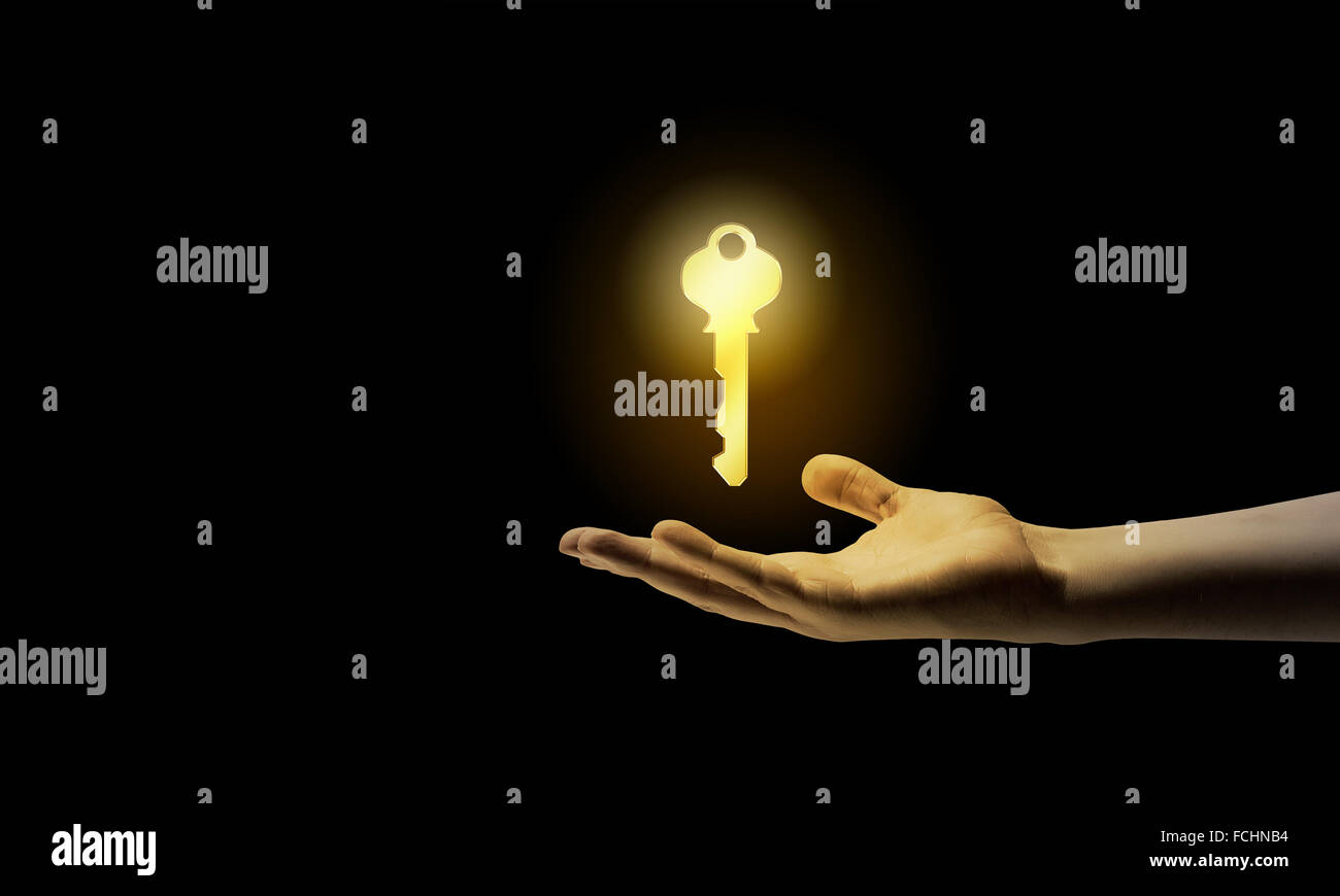 Close up image of business person holding shining key Stock Photo - Alamy