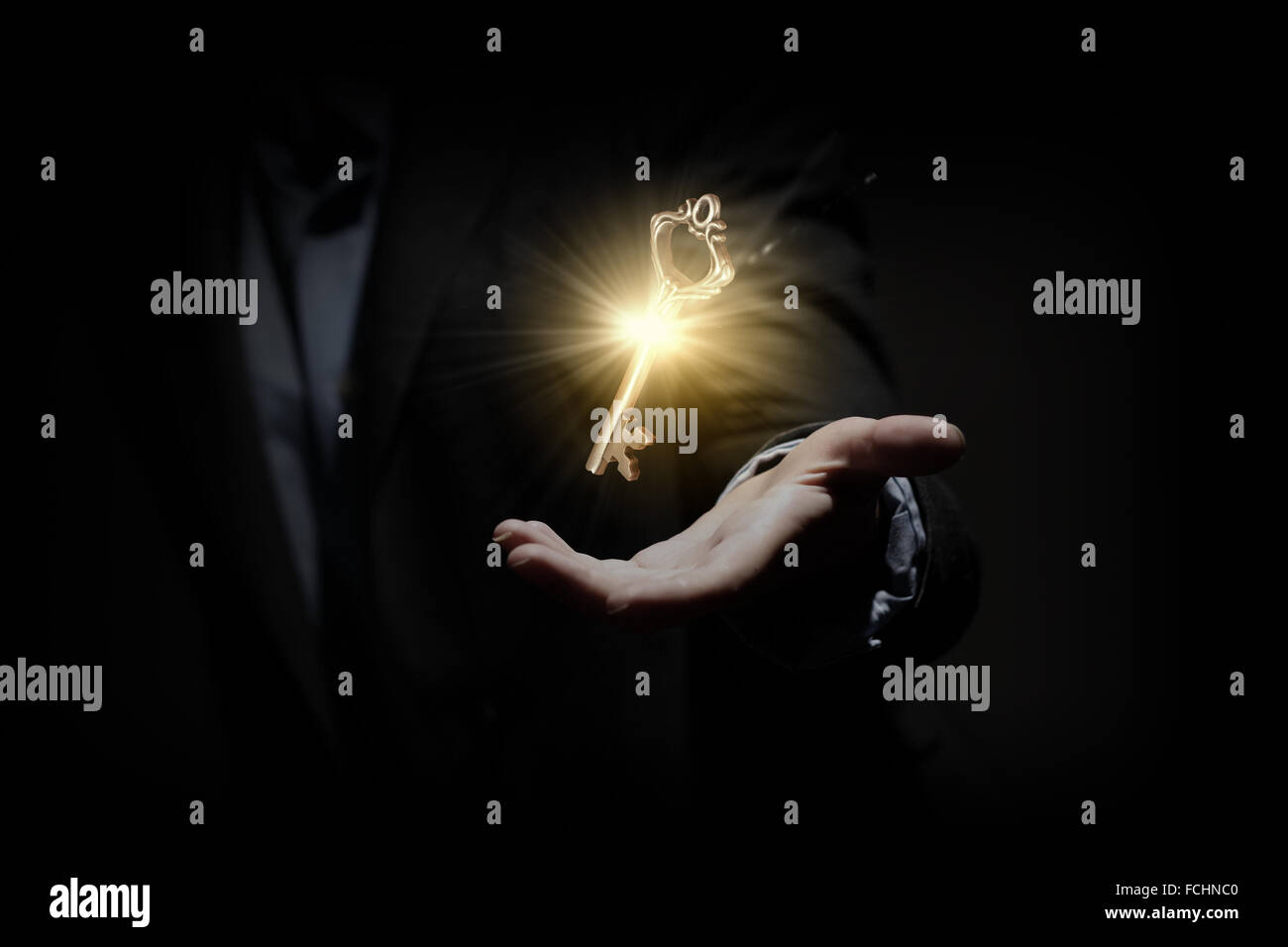 Close up image of business person holding shining key Stock Photo - Alamy
