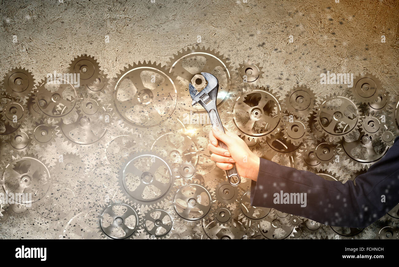 Close up of businessman hand fixing mechanism with spanner Stock Photo ...