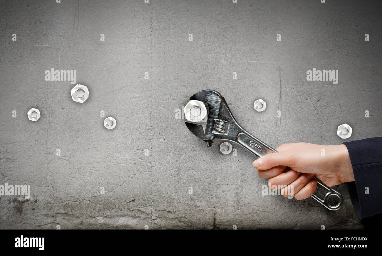 Close up of businessman hand fixing mechanism with spanner Stock Photo ...