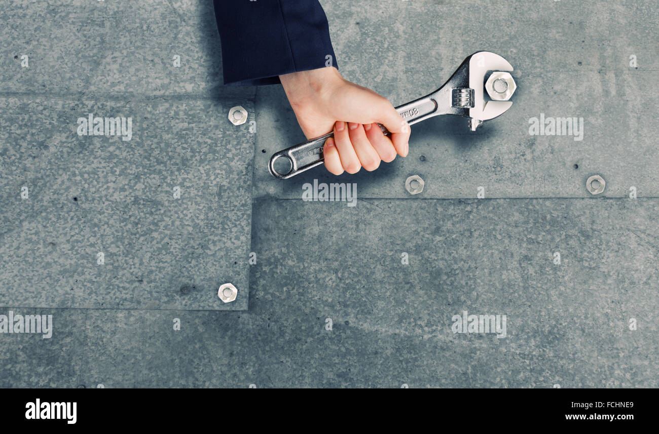 Close up of businessman hand fixing mechanism with spanner Stock Photo ...
