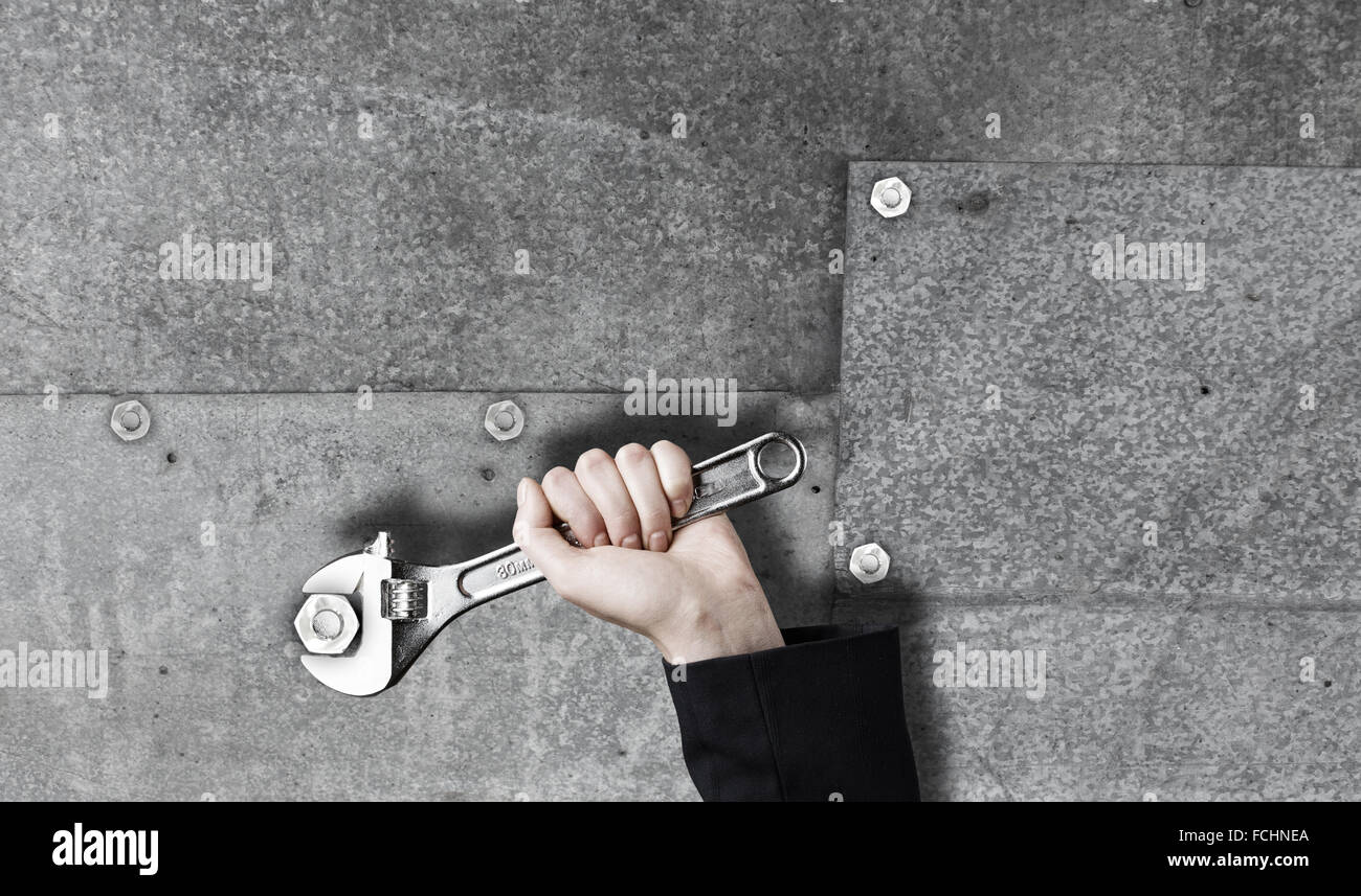 Close up of businessman hand fixing mechanism with spanner Stock Photo ...