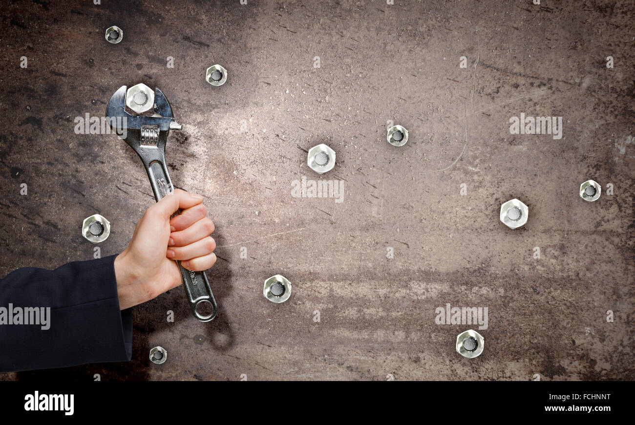 Close up of businessman hand fixing mechanism with spanner Stock Photo ...