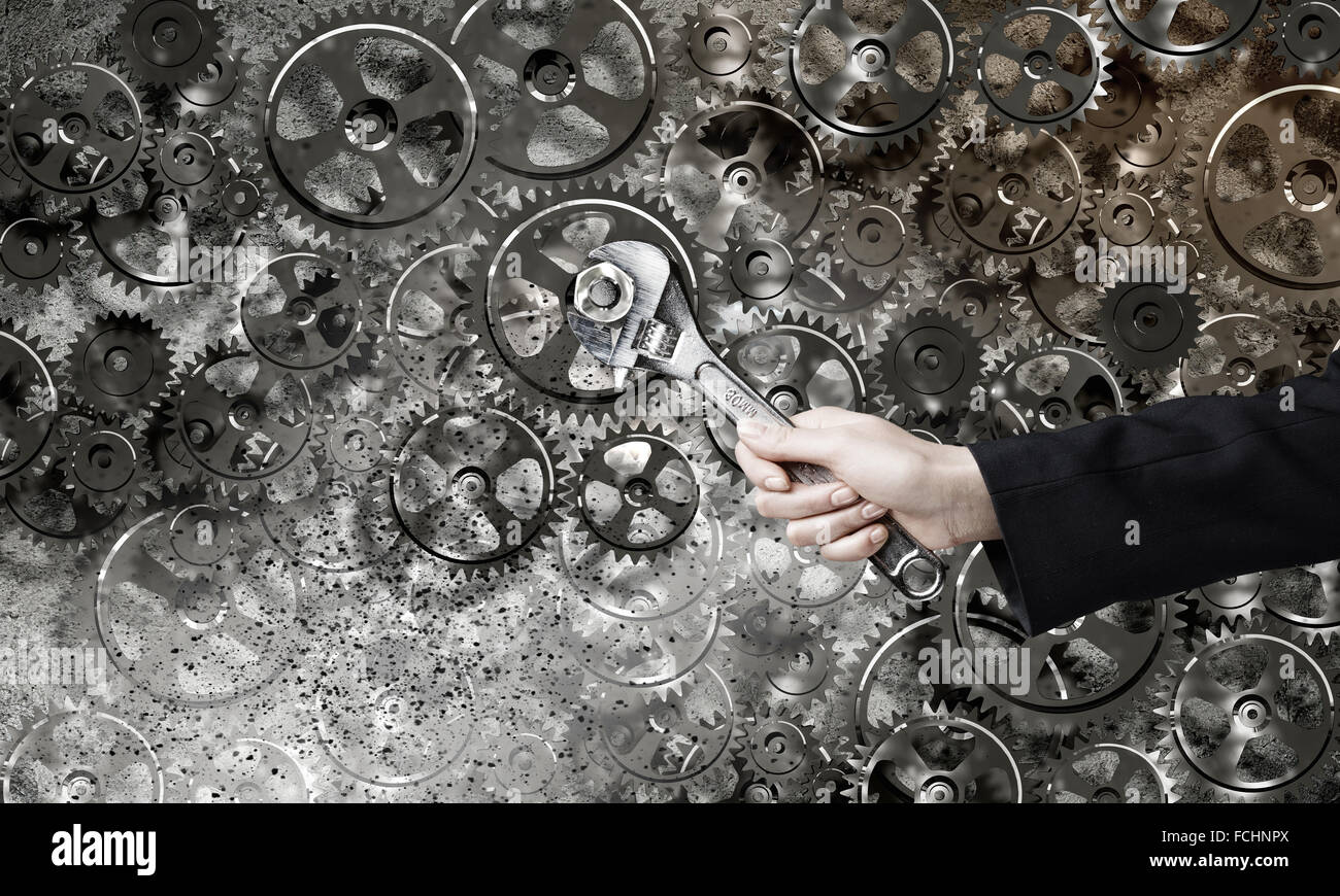 Close up of businessman hand fixing mechanism with spanner Stock Photo ...
