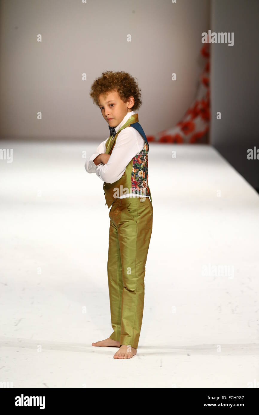 A kid model walks the runway at the Nancy Vuu fashion show during ...