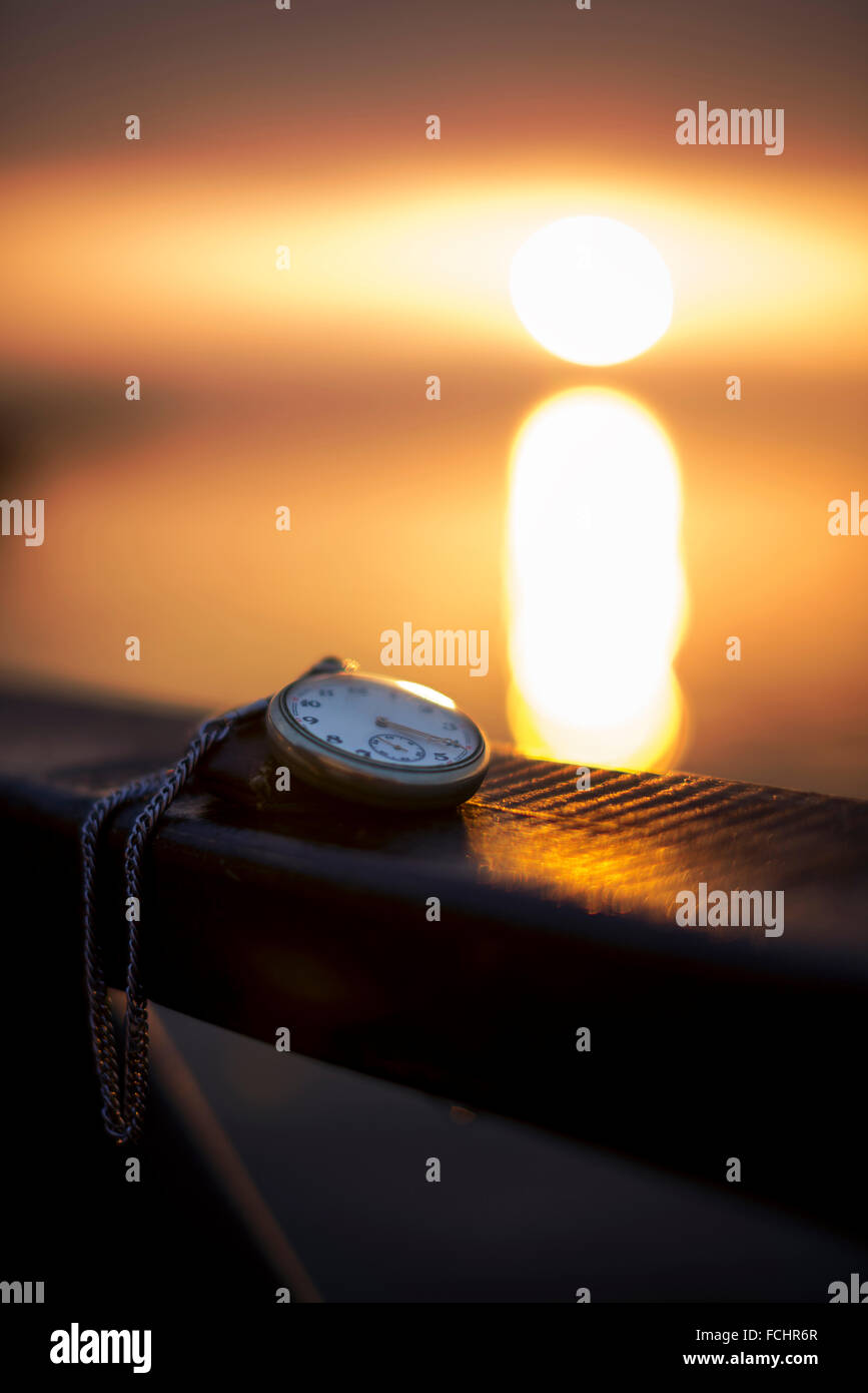 Pocket watch and chain on sunset near the waters edge Stock Photo - Alamy