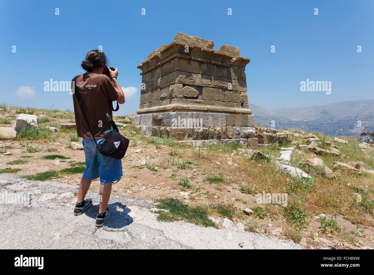 Male tourist taking picture at the ancient ruins in Faqra near Faraya ...