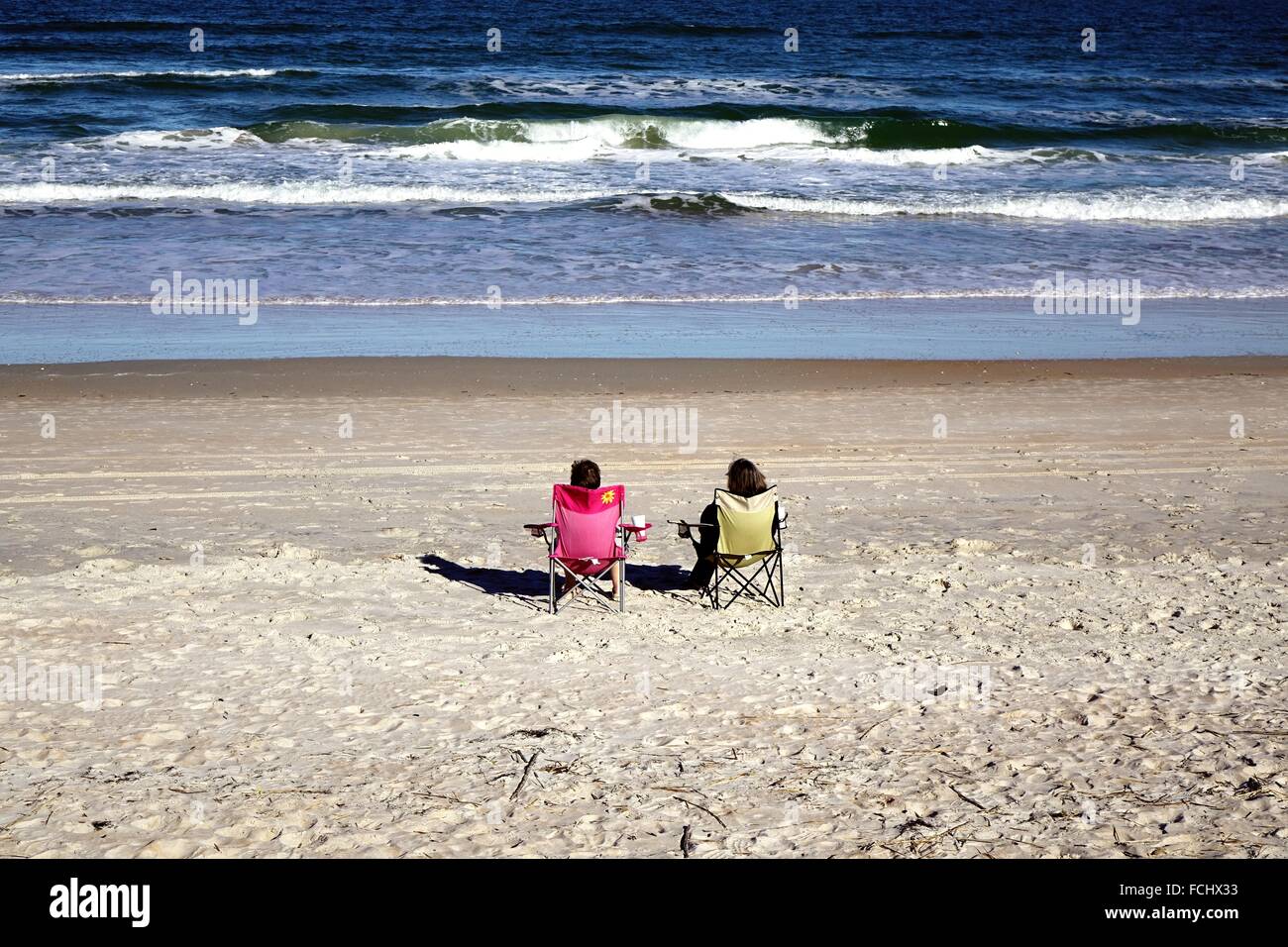 People sitting in beach chairs hi-res stock photography and images - Alamy