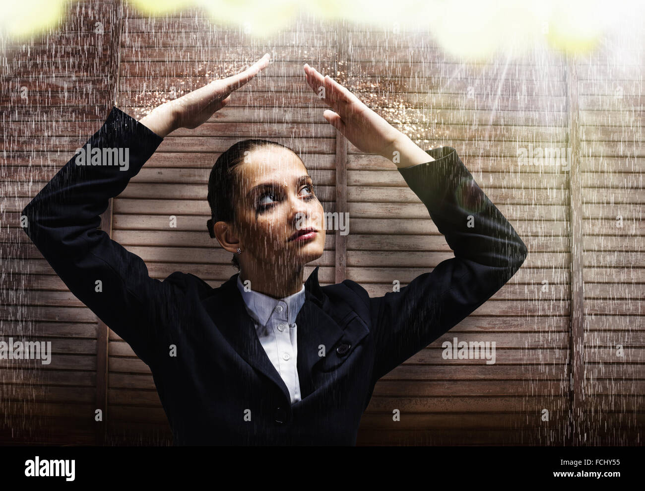 Young businesswoman protecting her head from rain with hands Stock ...