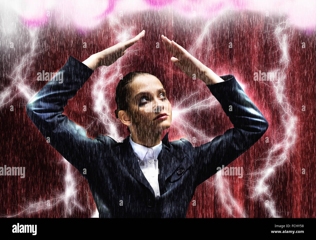 Young businesswoman protecting her head from rain with hands Stock ...