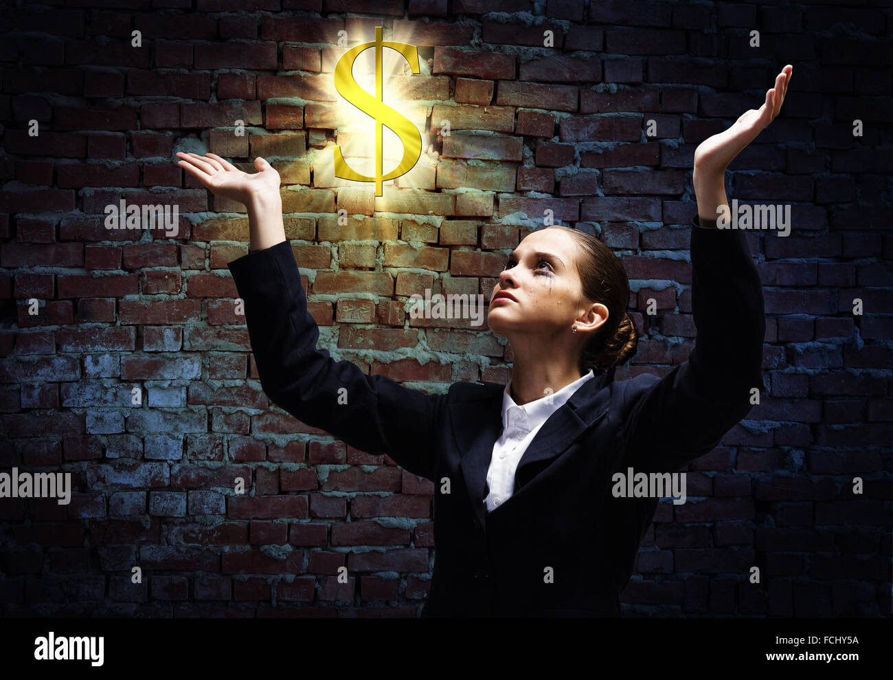 Young crying businesswoman praying on dollar symbol Stock Photo - Alamy