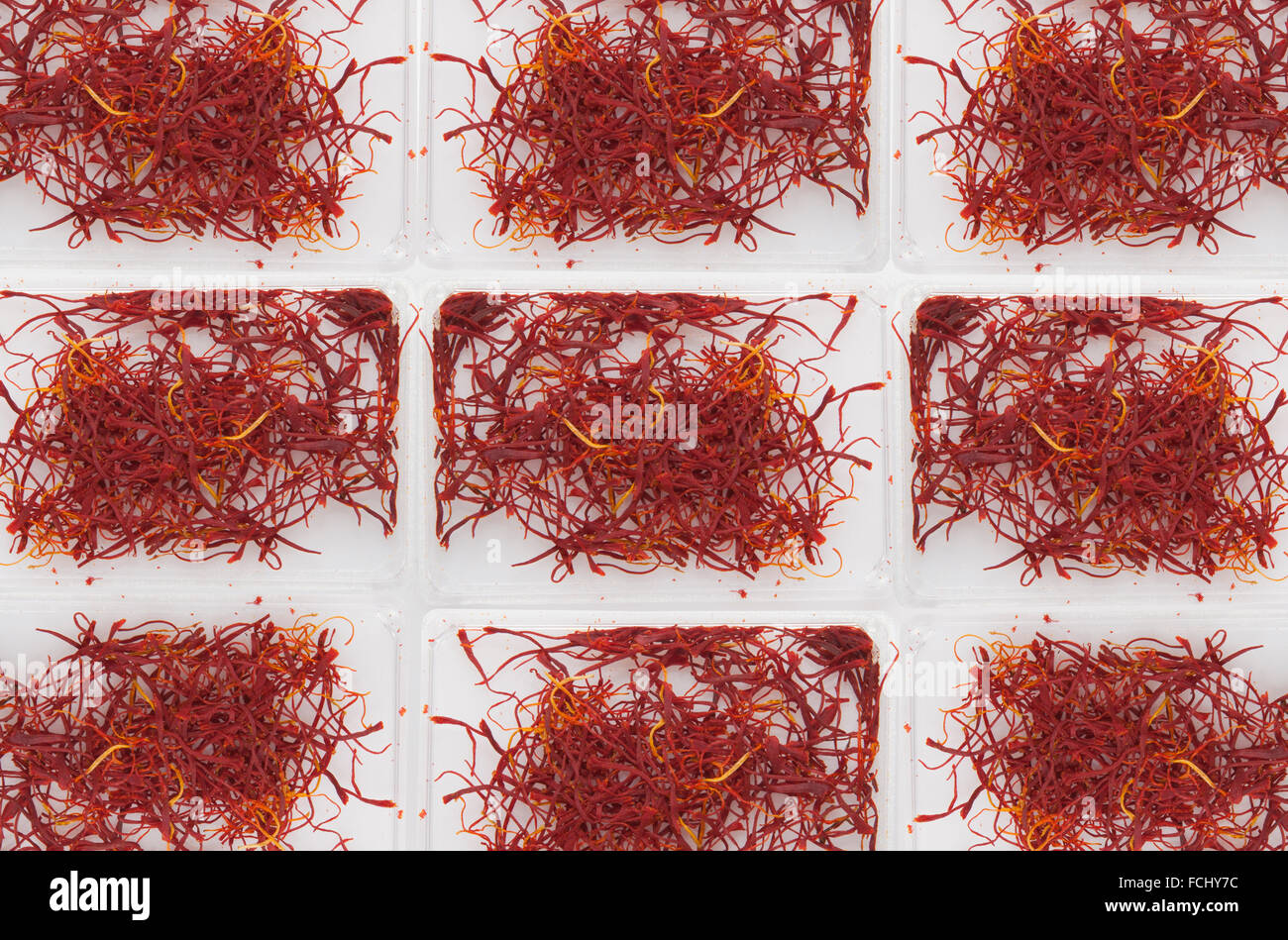 6 little plastic boxes of spanish Saffron Isolated on white background ...