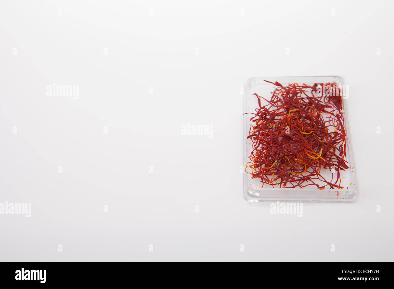 Little plastic box of spanish Saffron Isolated on white background ...