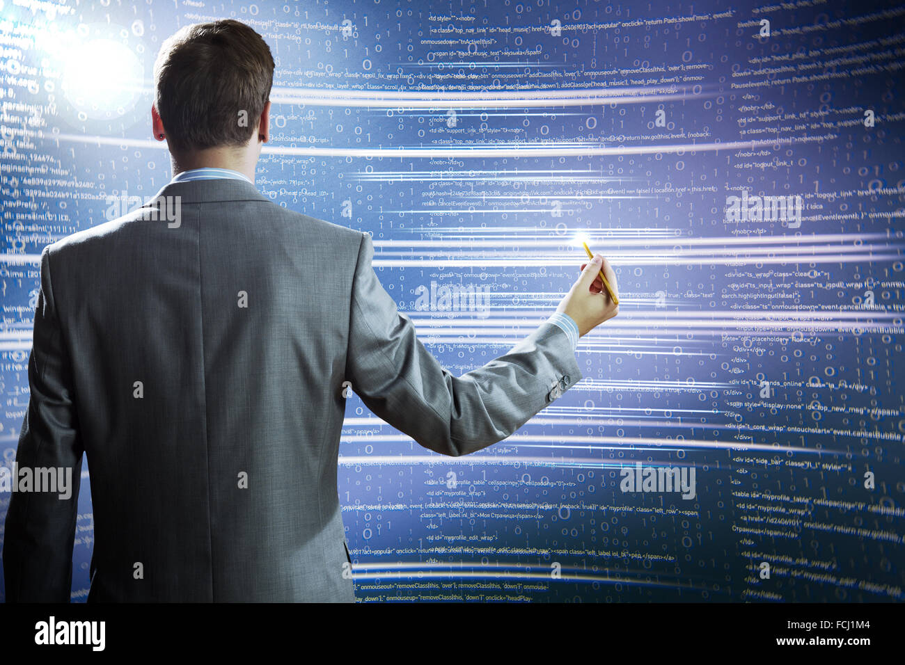 Rear view of businessman touching digital screen Stock Photo - Alamy