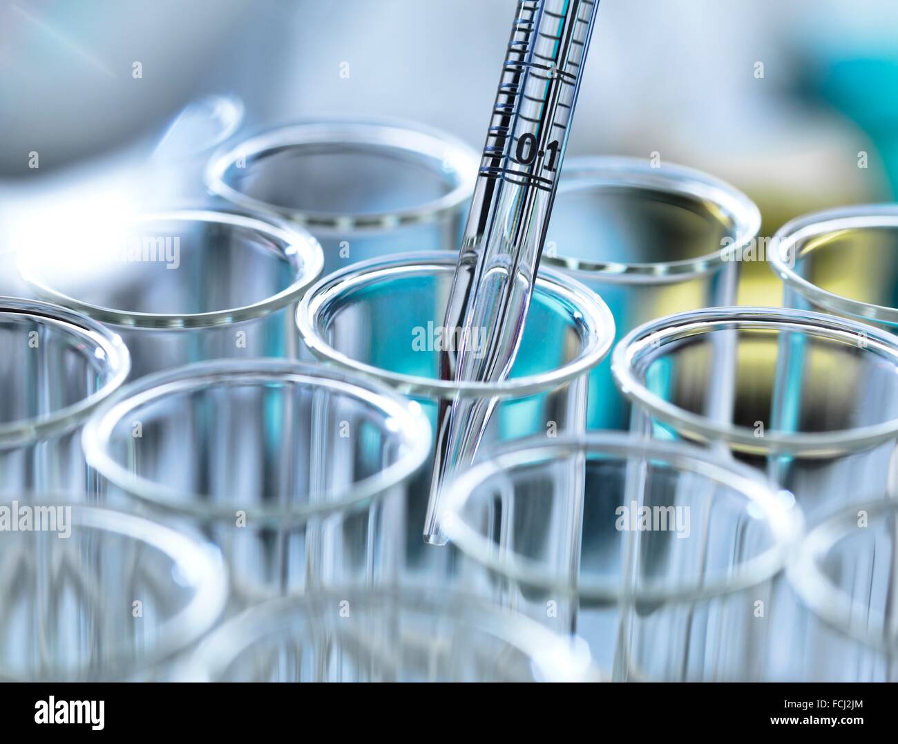 PROPERTY RELEASED. Graduated pipette placing a sample into test tubes ...