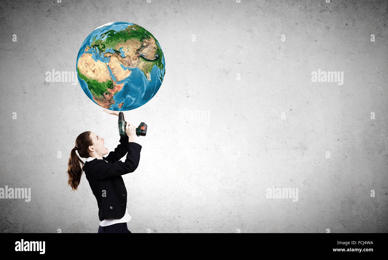Emotional businesswoman drilling Earth planet. Elements of this image ...