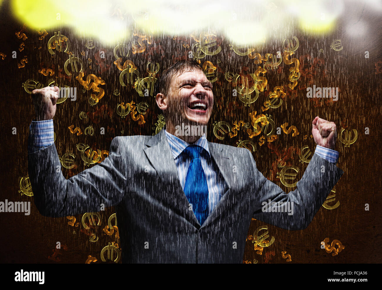 Young joyful businessman with hands up celebrating success Stock Photo ...