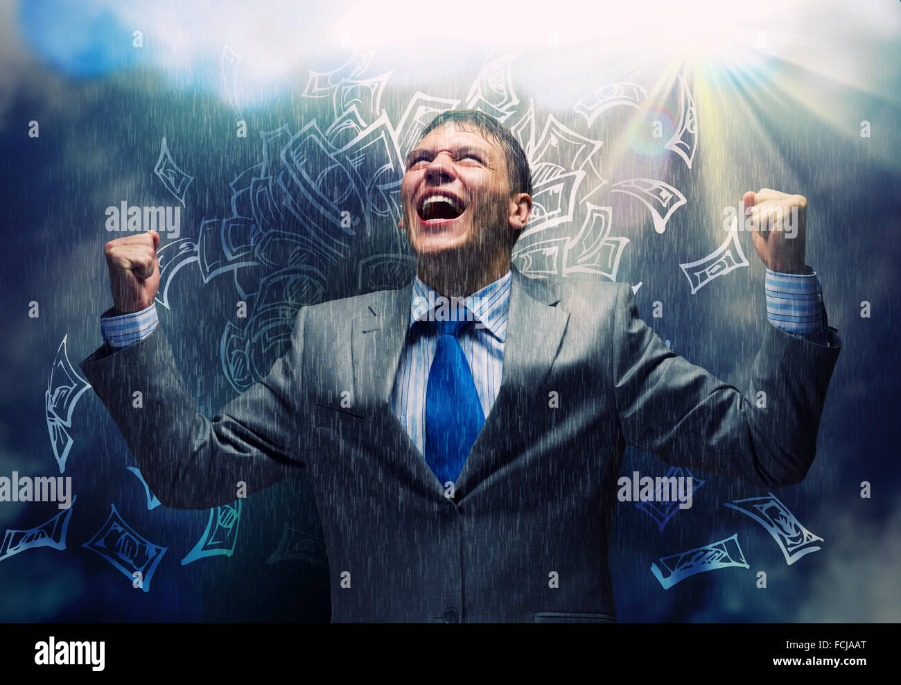 Young joyful businessman with hands up celebrating success Stock Photo ...