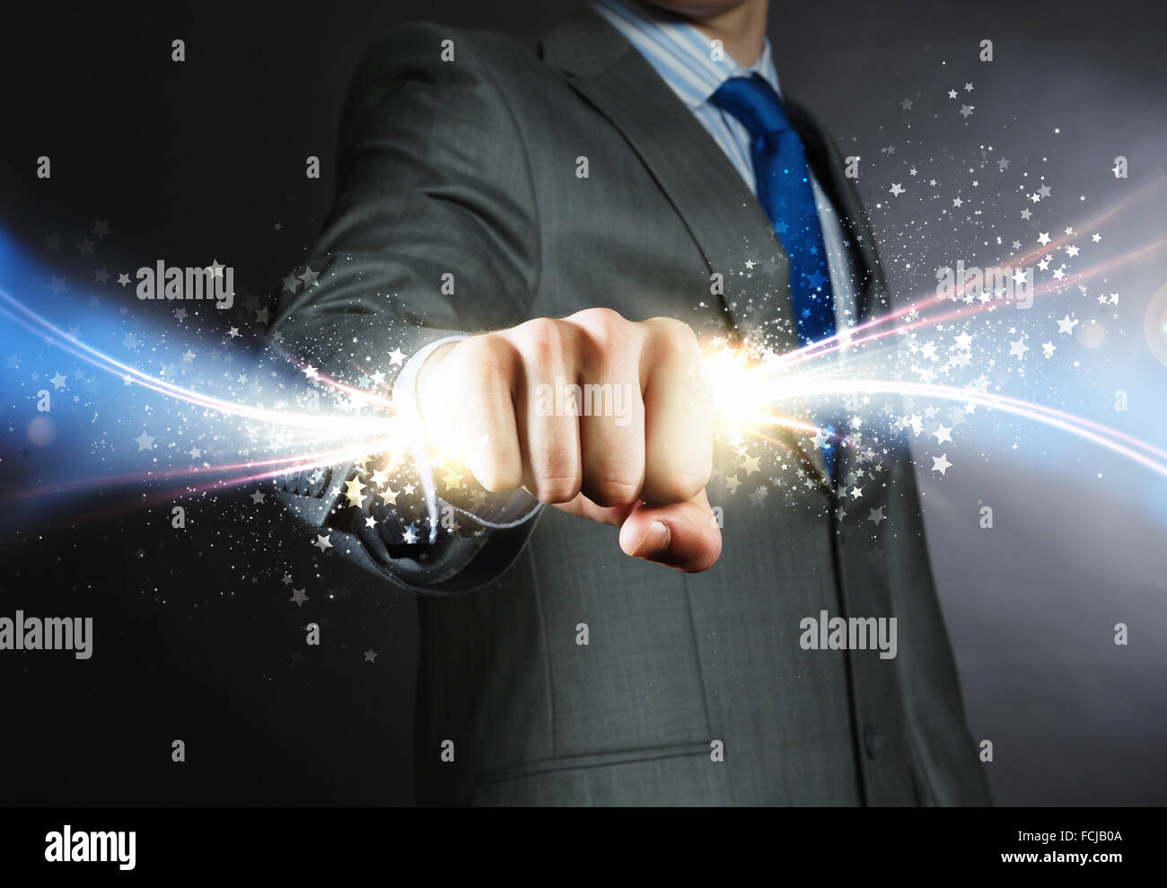 Close up of businessman grasping star dust in fist Stock Photo - Alamy