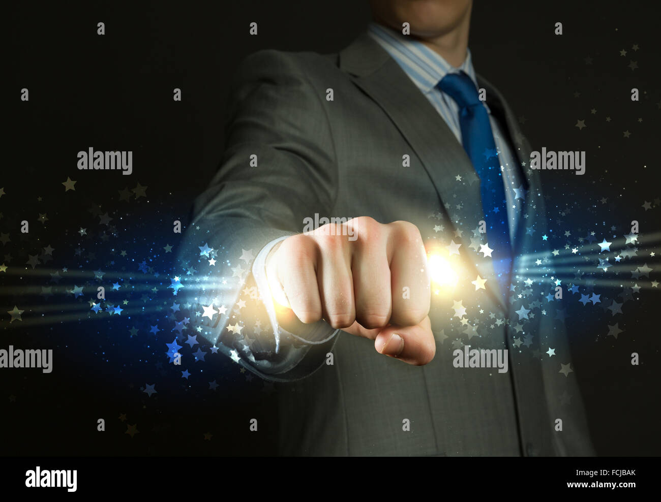 Close up of businessman grasping star dust in fist Stock Photo - Alamy