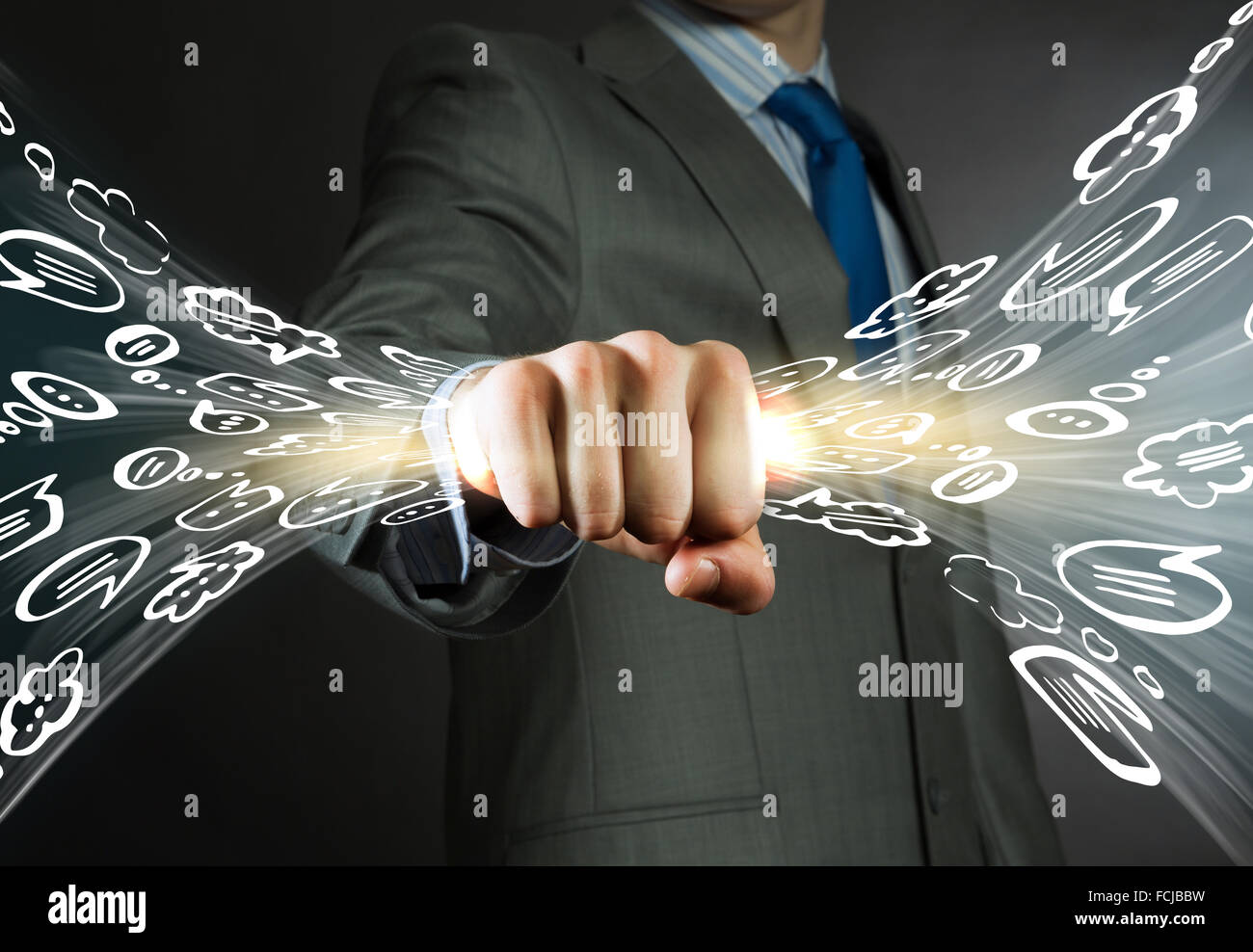 Close up of businessman grasping light in fist Stock Photo - Alamy
